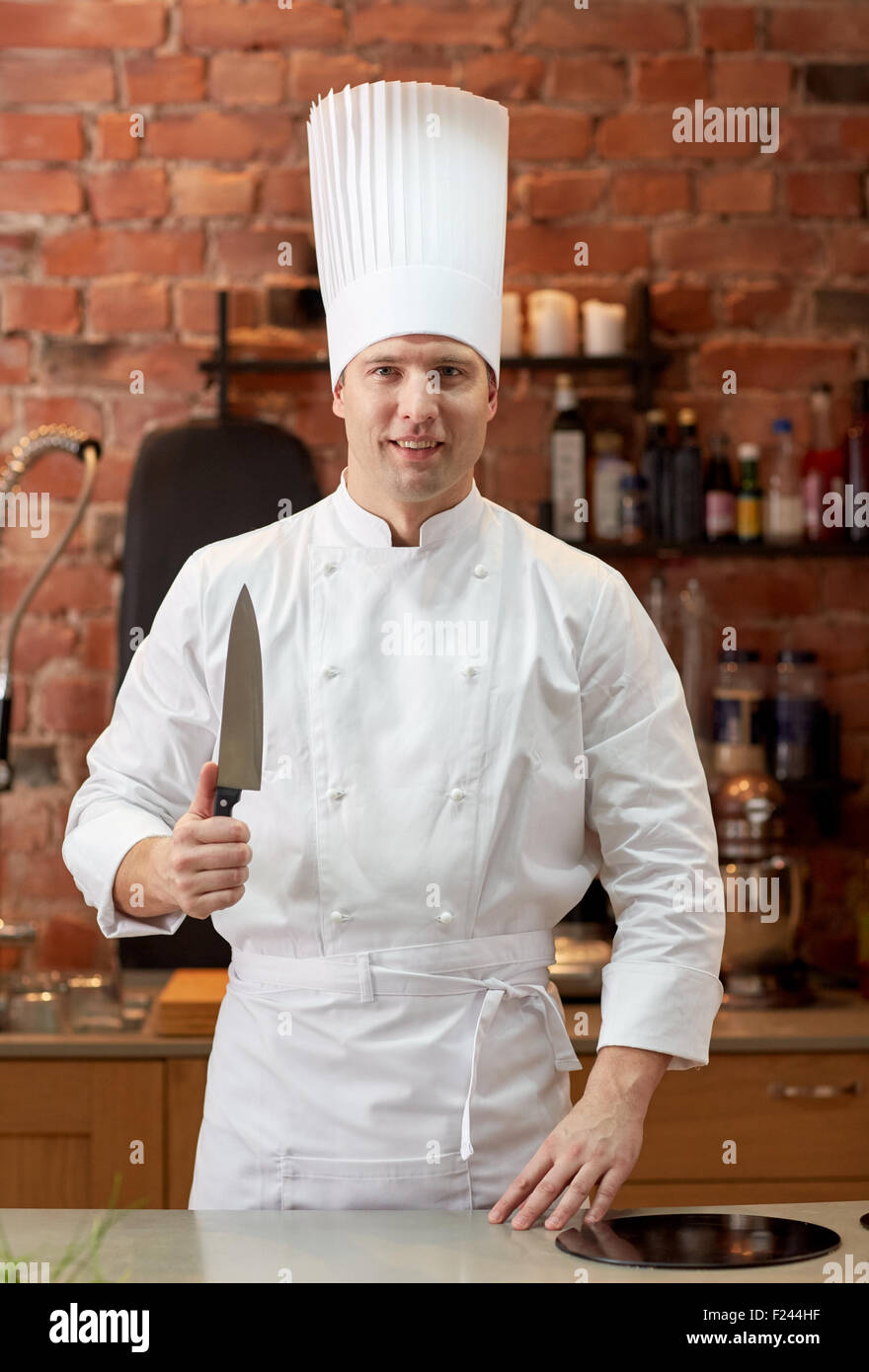 happy male chef cook in kitchen with knife Stock Photo - Alamy