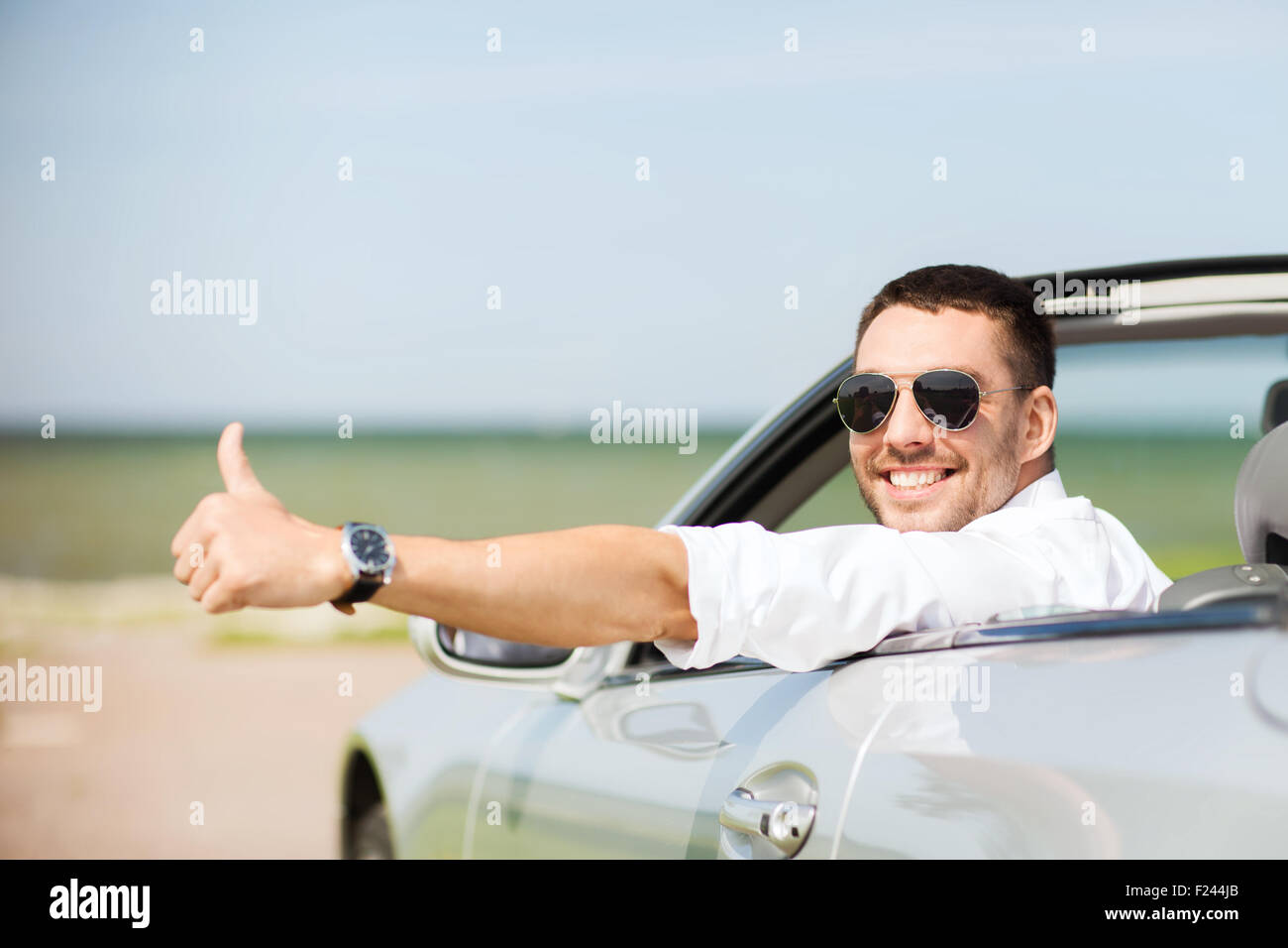 happy man driving car and showing thumbs up Stock Photo - Alamy