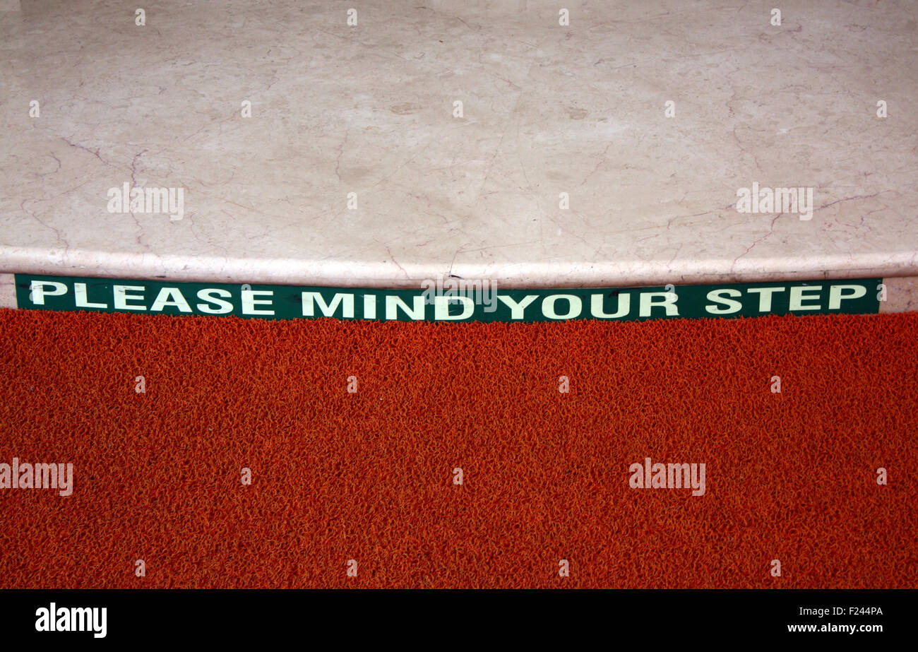 A 'Mind Your Step' sign on a marble step Stock Photo - Alamy