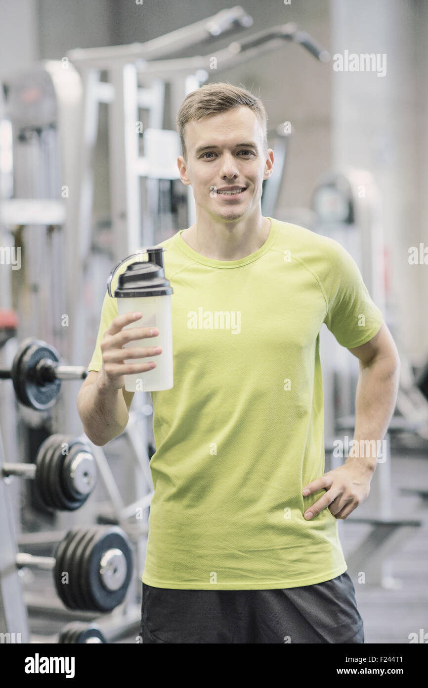 smiling man with protein shake bottle Stock Photo - Alamy
