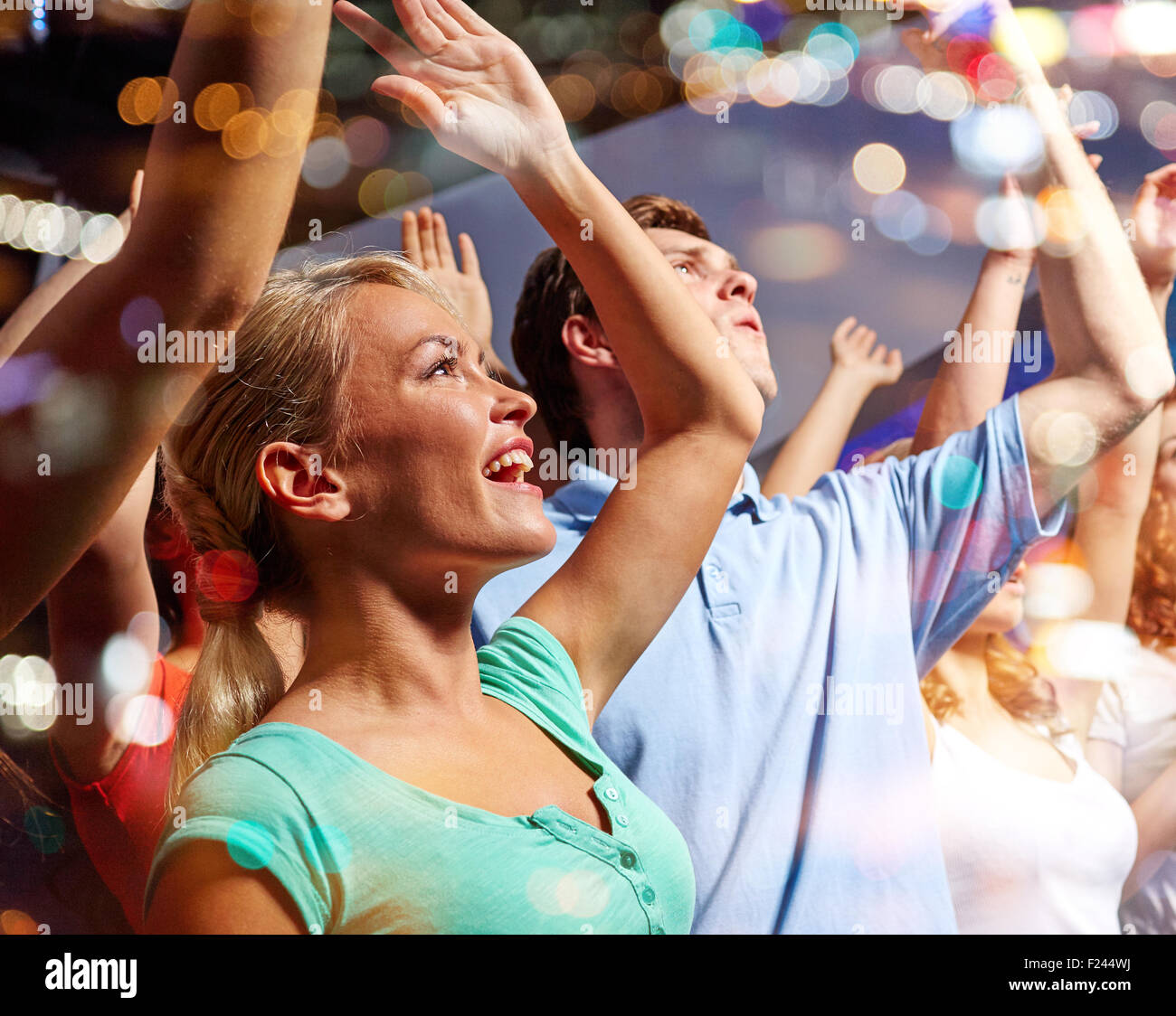 smiling friends at concert in club Stock Photo - Alamy