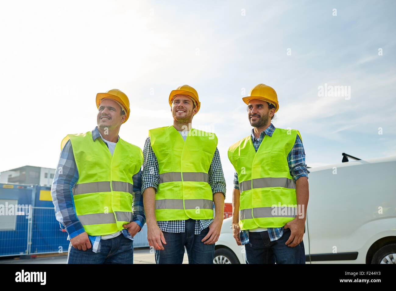 happy male builders in high visible vests outdoors Stock Photo - Alamy