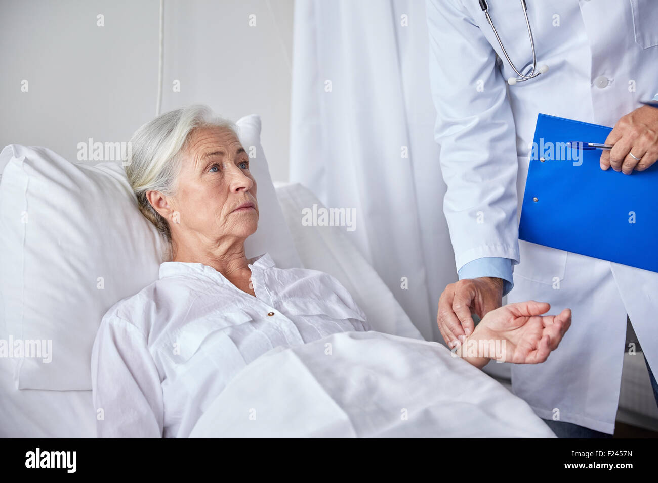 doctor checking senior woman pulse at hospital Stock Photo - Alamy