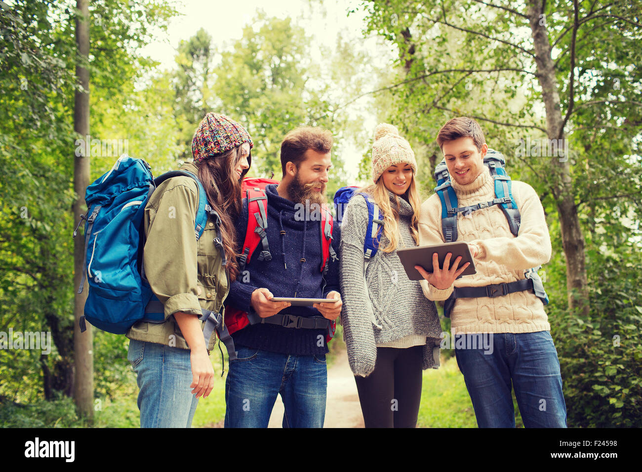 group of friends with backpacks and tablet pc Stock Photo - Alamy