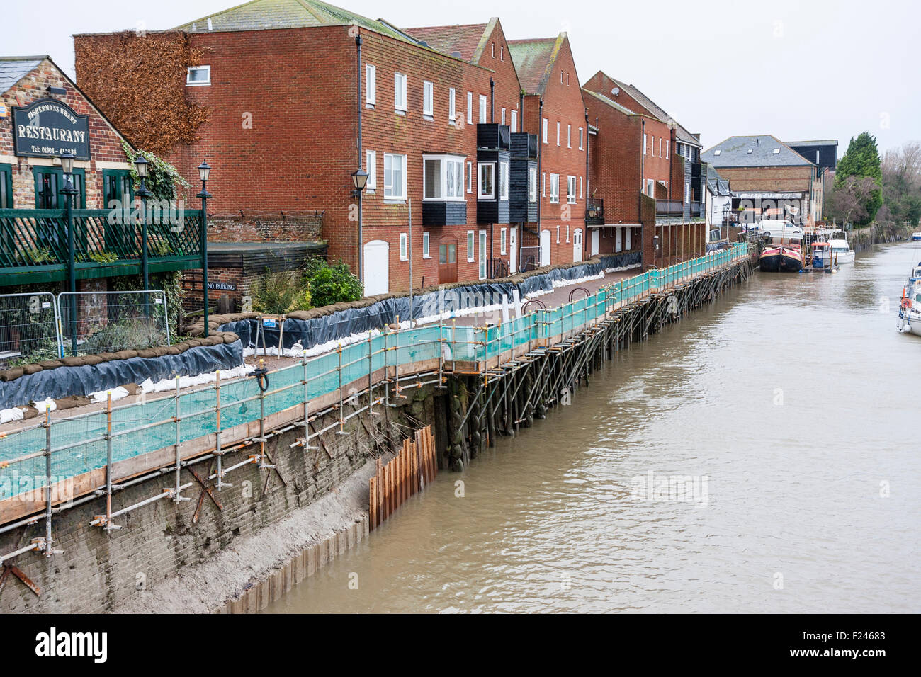 Emergency urgent flood defences being constructed along the quay at ...