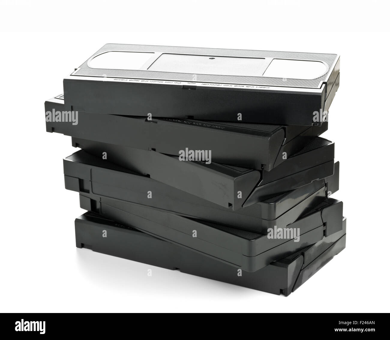 Stack of analog video home system (VHS) tape over white background ...