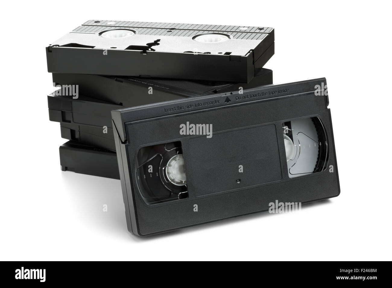 Stack of analog video home system (VHS) tape over white background ...