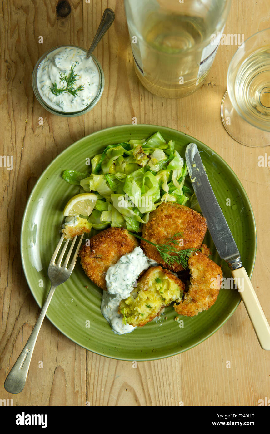 Spiced fishcakes with spring cabbage and tartare sauce. a UK meal ...