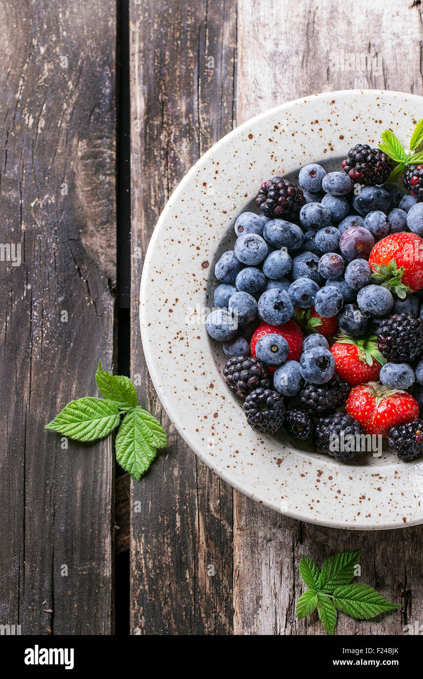 Spotted ceramic plate of assortment berries blueberries, strawberries ...