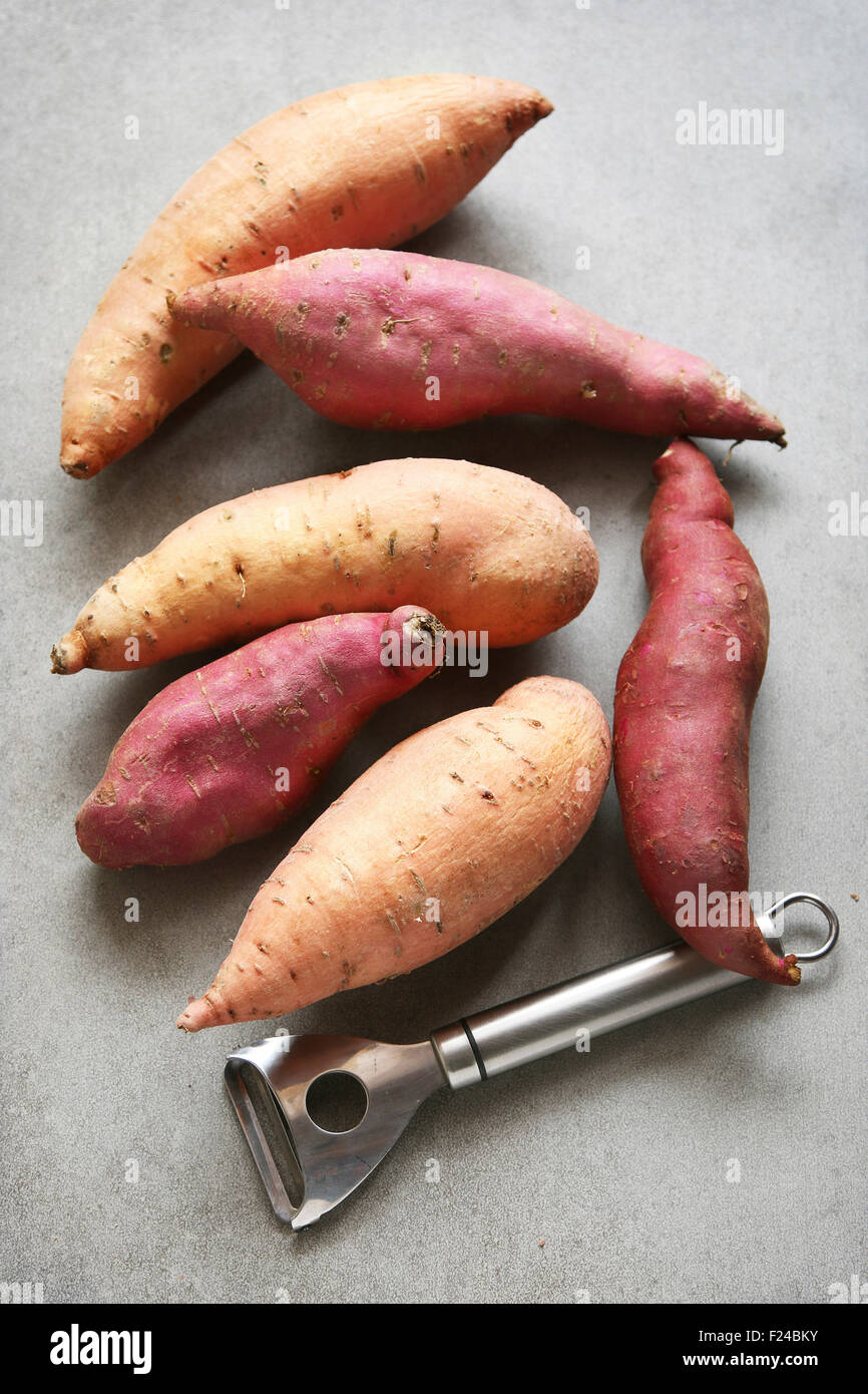 Two different varieties of sweet potatoes on grey background Stock ...
