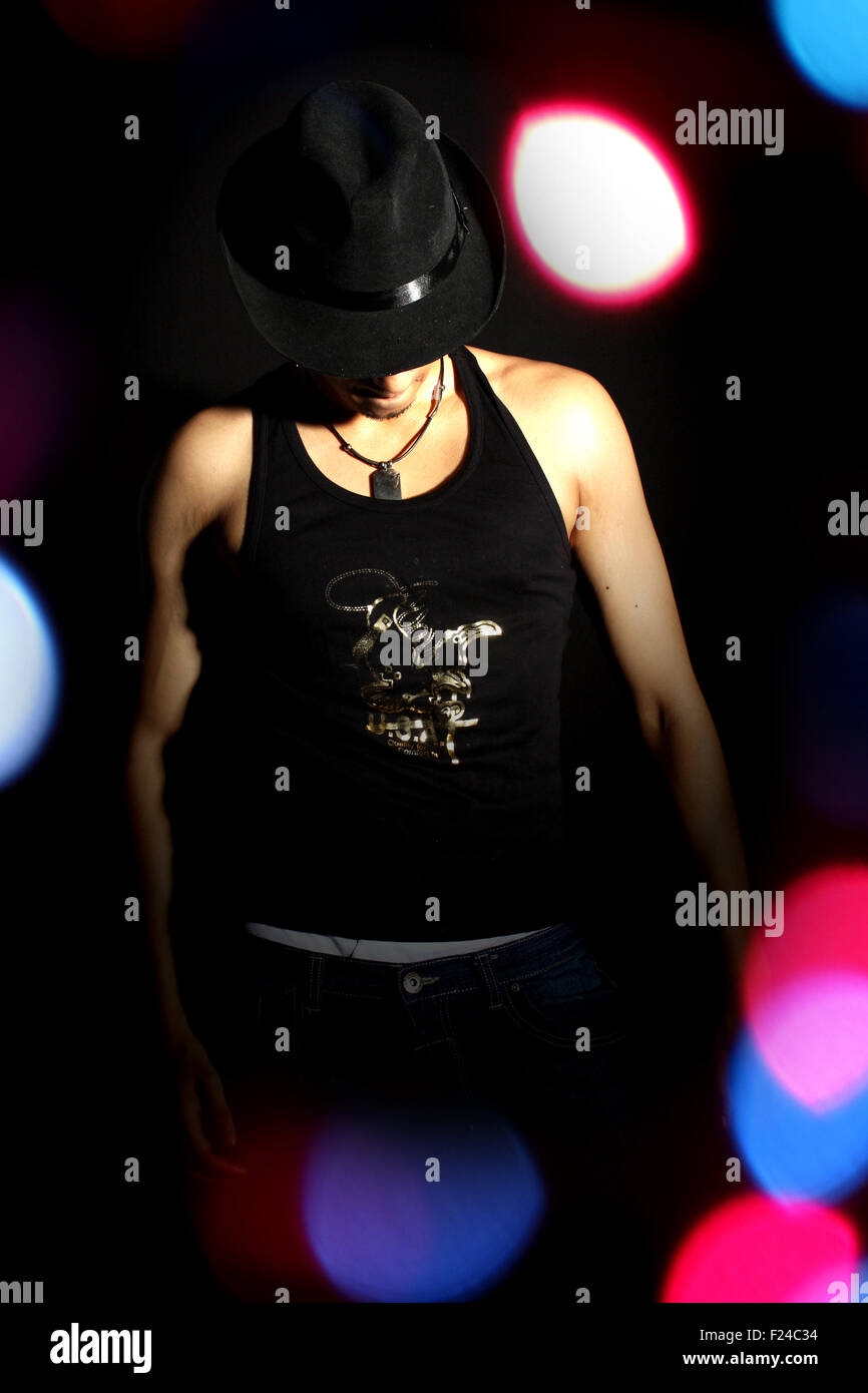 A Stylish Dancer in a spotlight and colorful lights Stock Photo - Alamy