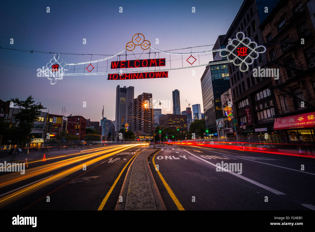 Welcome to Chinatown sign and traffic on Bowery during twilight, in ...