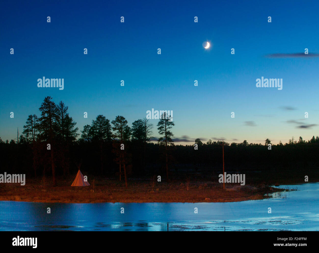 A crescent moon appears over a tee pee in Bryce Canyon National Park ...