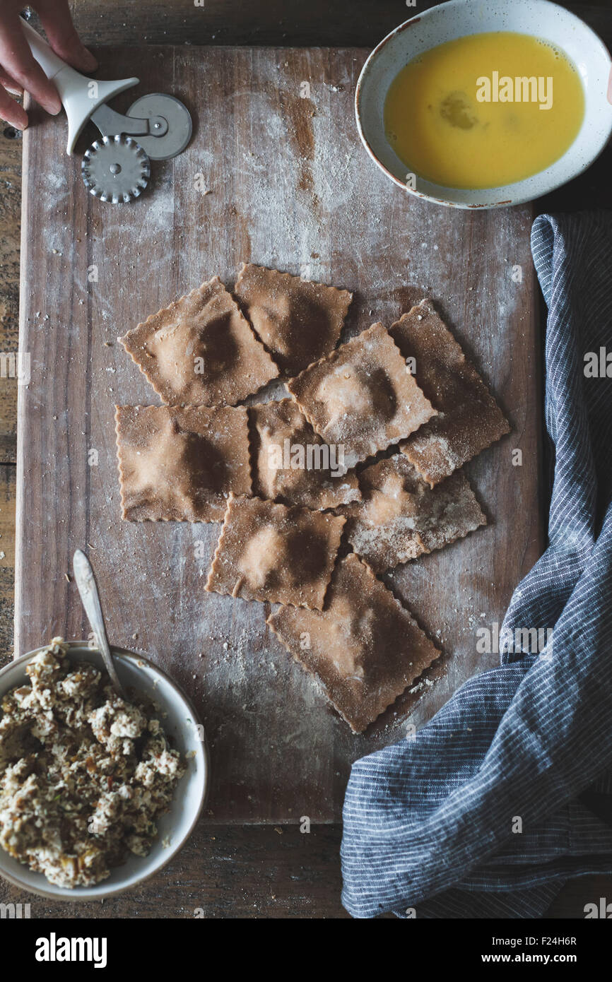 The cooking of chestnut flour ravioli with artichokes, peas and enoki ...