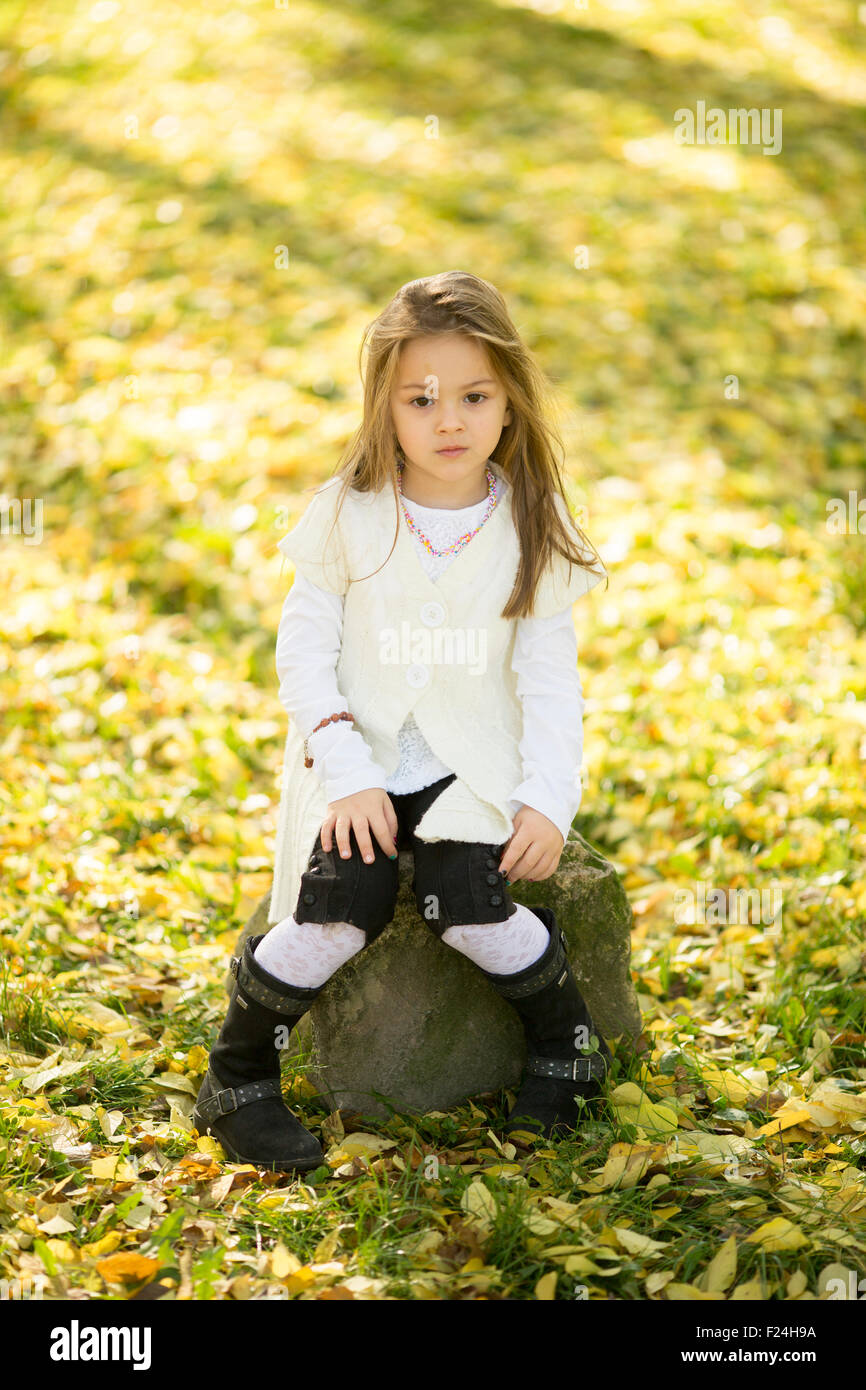 Little girl at the autumn park Stock Photo - Alamy