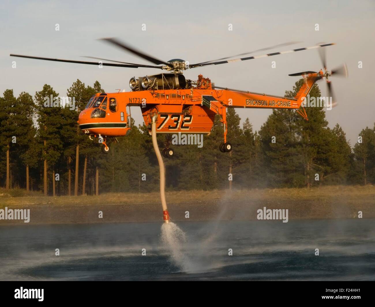 A S-64 Erickson Air-Crane helicopter pulls a load of water to fight the ...