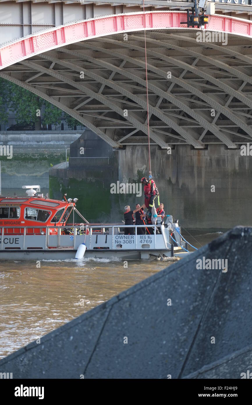 Firemen rescue a man who had climbed underneath Lambeth Bridge. The ...