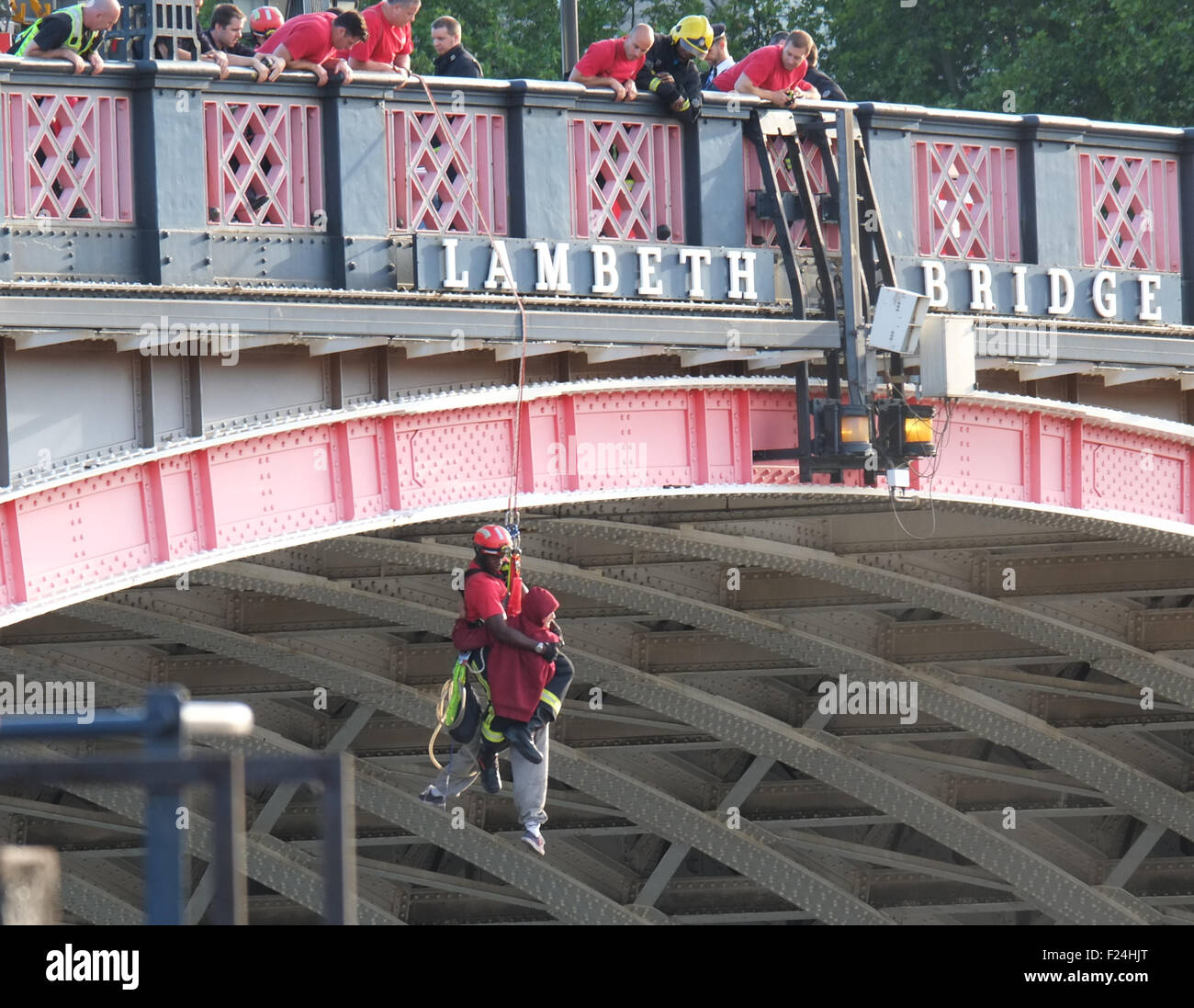 Firemen rescue a man who had climbed underneath Lambeth Bridge. The ...