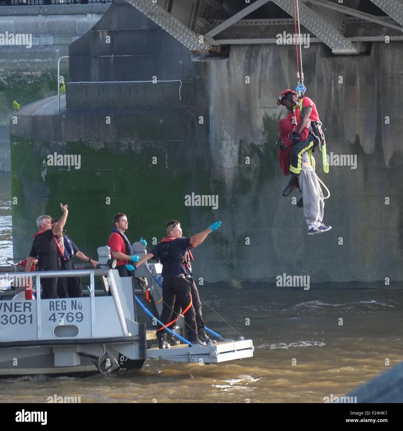Firemen rescue a man who had climbed underneath Lambeth Bridge. The ...