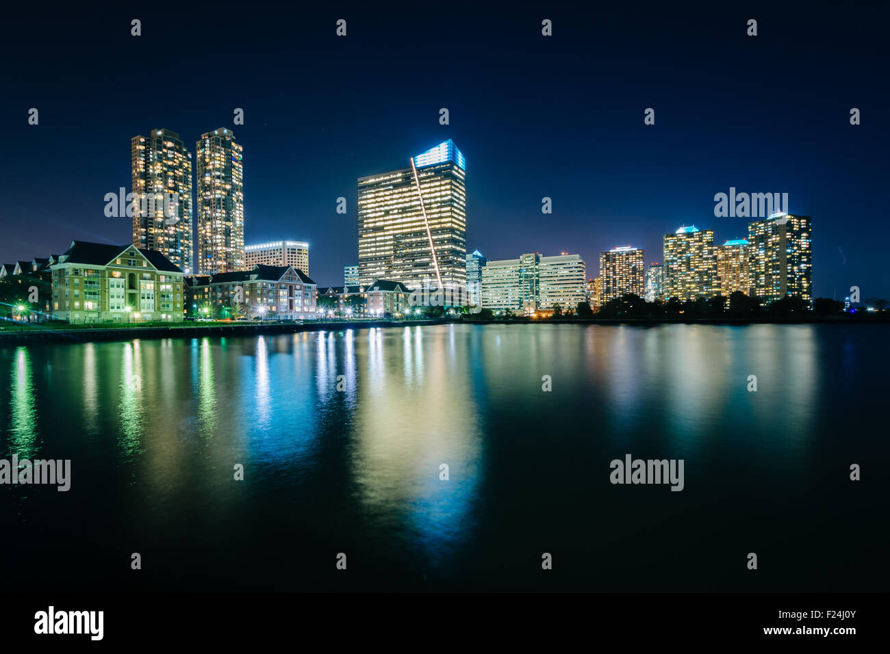 Buildings along the waterfront at night, in Jersey City, New Jersey ...