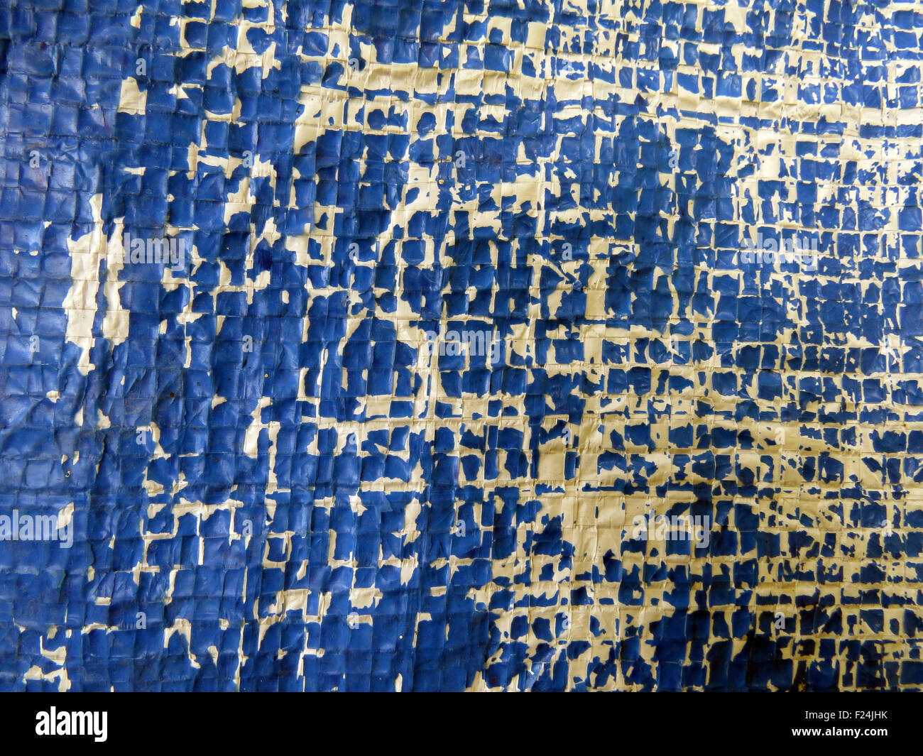A background with a close view of an old worn plastic surface of blue ...