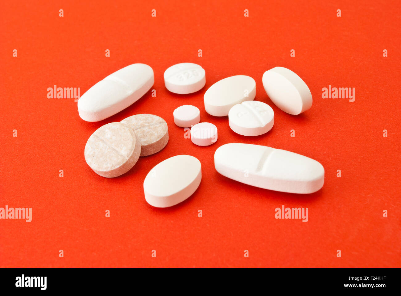 Various kinds of tablets on the red background Stock Photo - Alamy