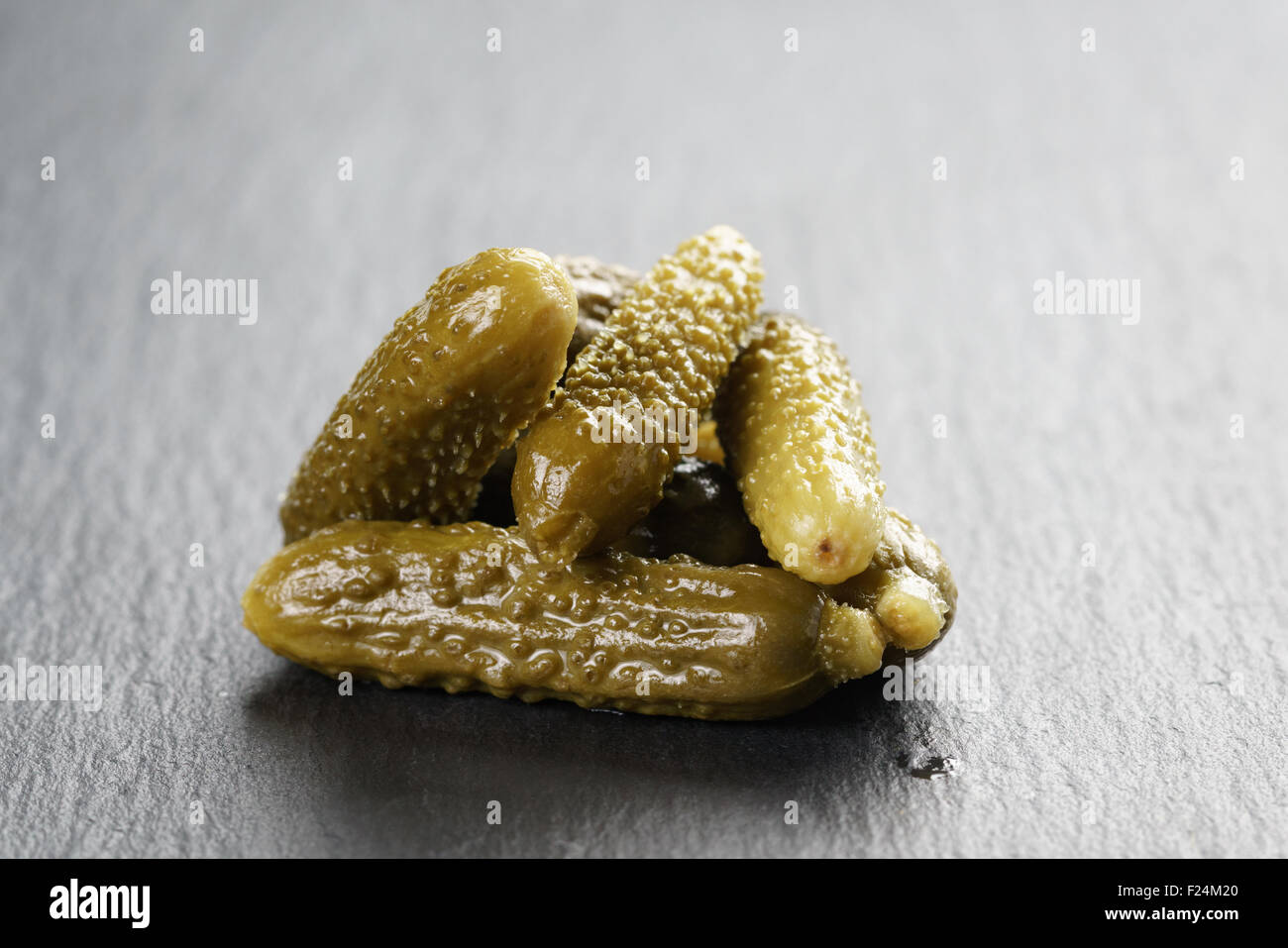 marinated cornichons on slate background Stock Photo - Alamy