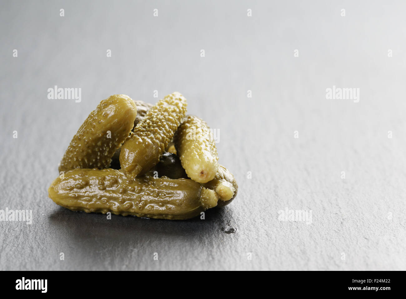 marinated cornichons on slate background Stock Photo - Alamy