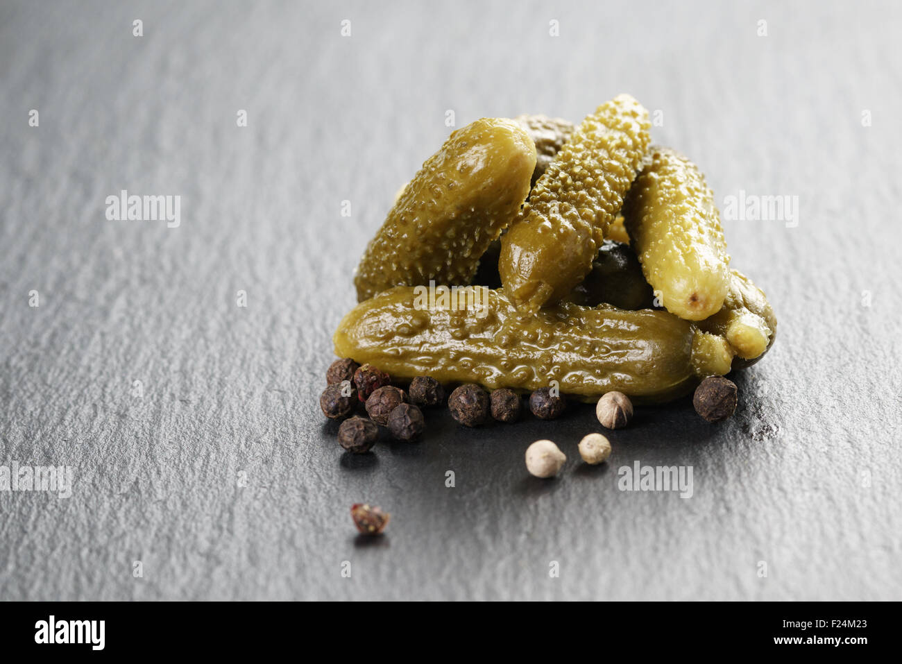 marinated cornichons on slate background Stock Photo - Alamy