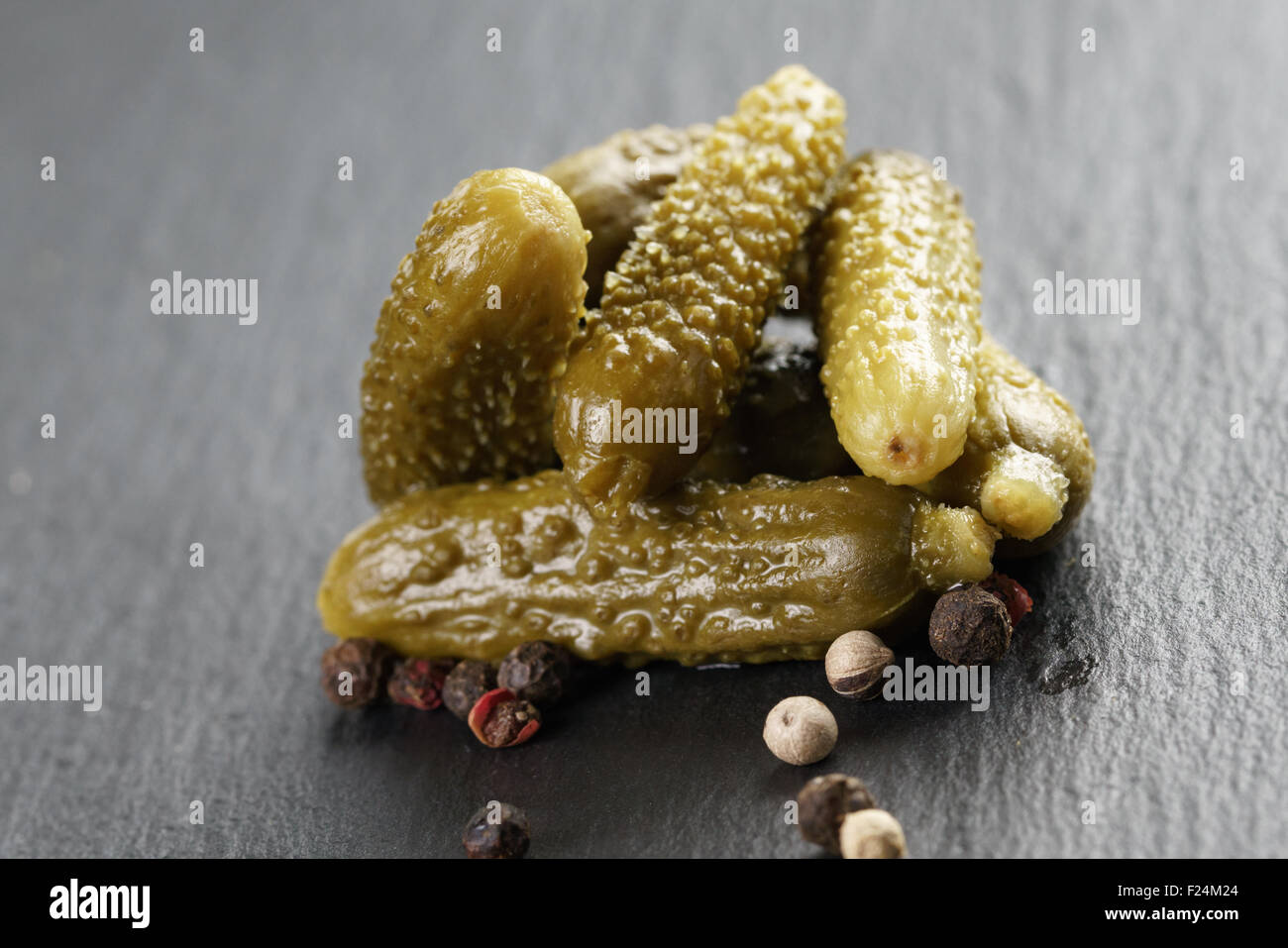 marinated cornichons on slate background Stock Photo - Alamy