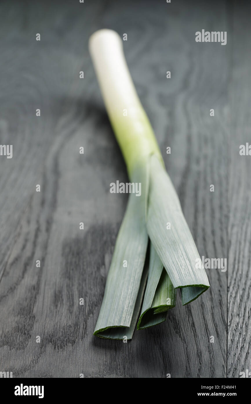 whole fresh leek on wood table Stock Photo - Alamy