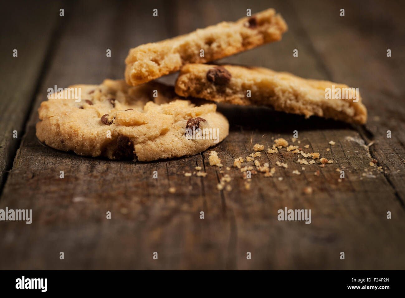 Chewy chocolate chip cookies on a wooden table sat on hessian Stock ...