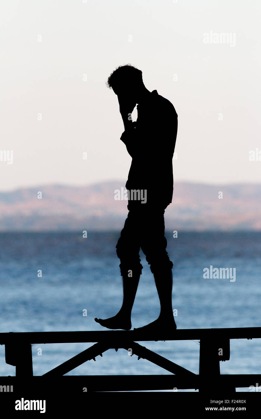 Man talking on cell phone next to water Stock Photo - Alamy