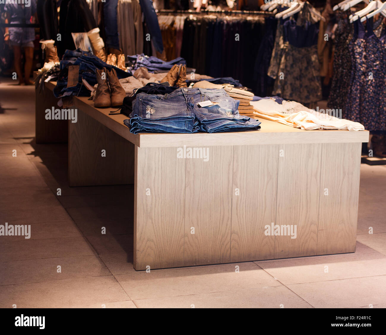 Clothes on a table in a Clothing store Stock Photo - Alamy
