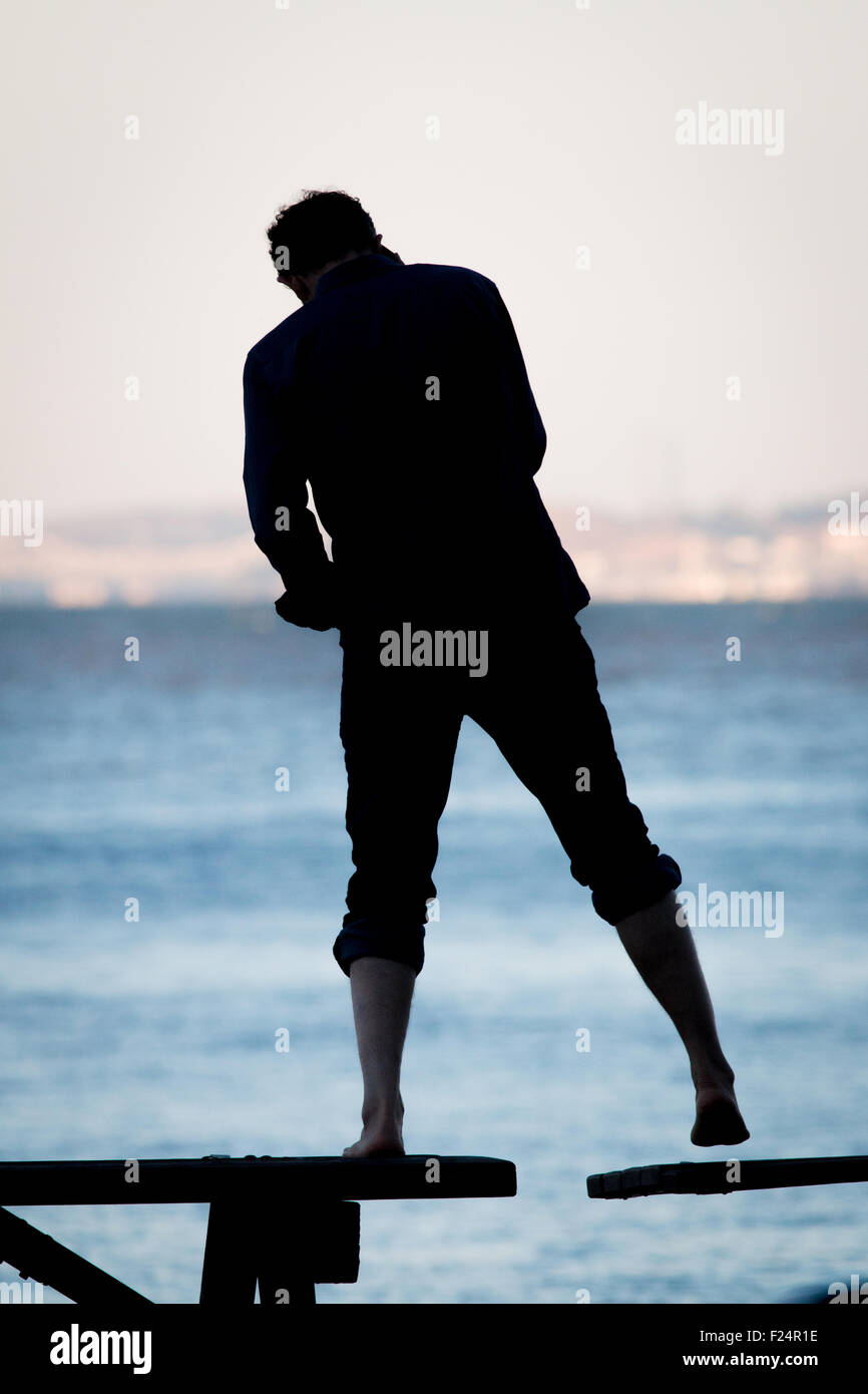Man talking on cell phone next to water Stock Photo - Alamy