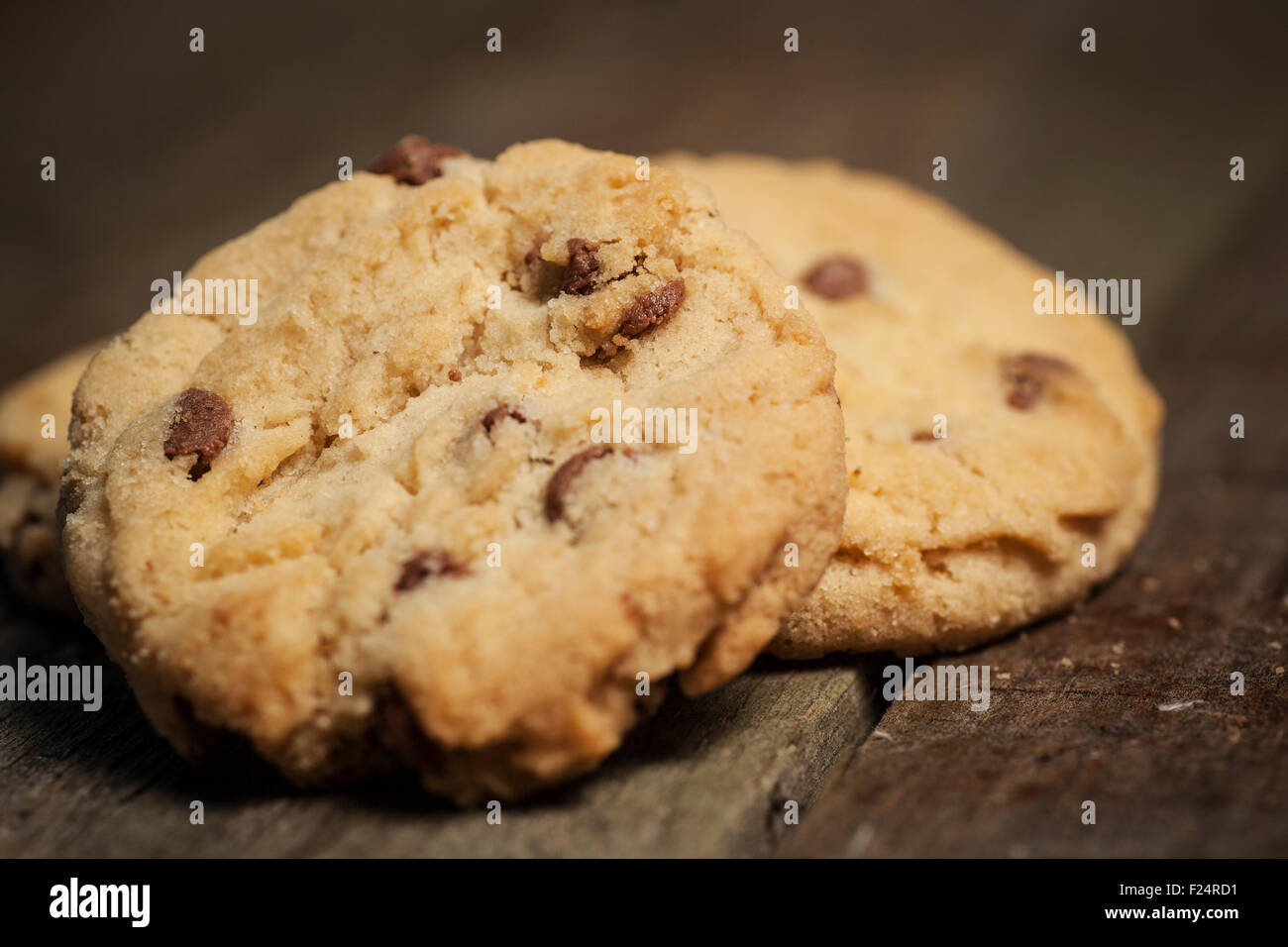 Chewy chocolate chip cookies on a wooden table sat on hessian Stock ...