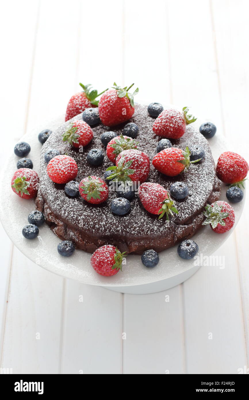 Chocolate cake with berries on top Stock Photo - Alamy