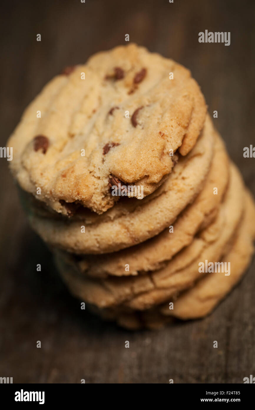 Stack of chewy chocolate chip cookies on a wooden table sat on hessian ...