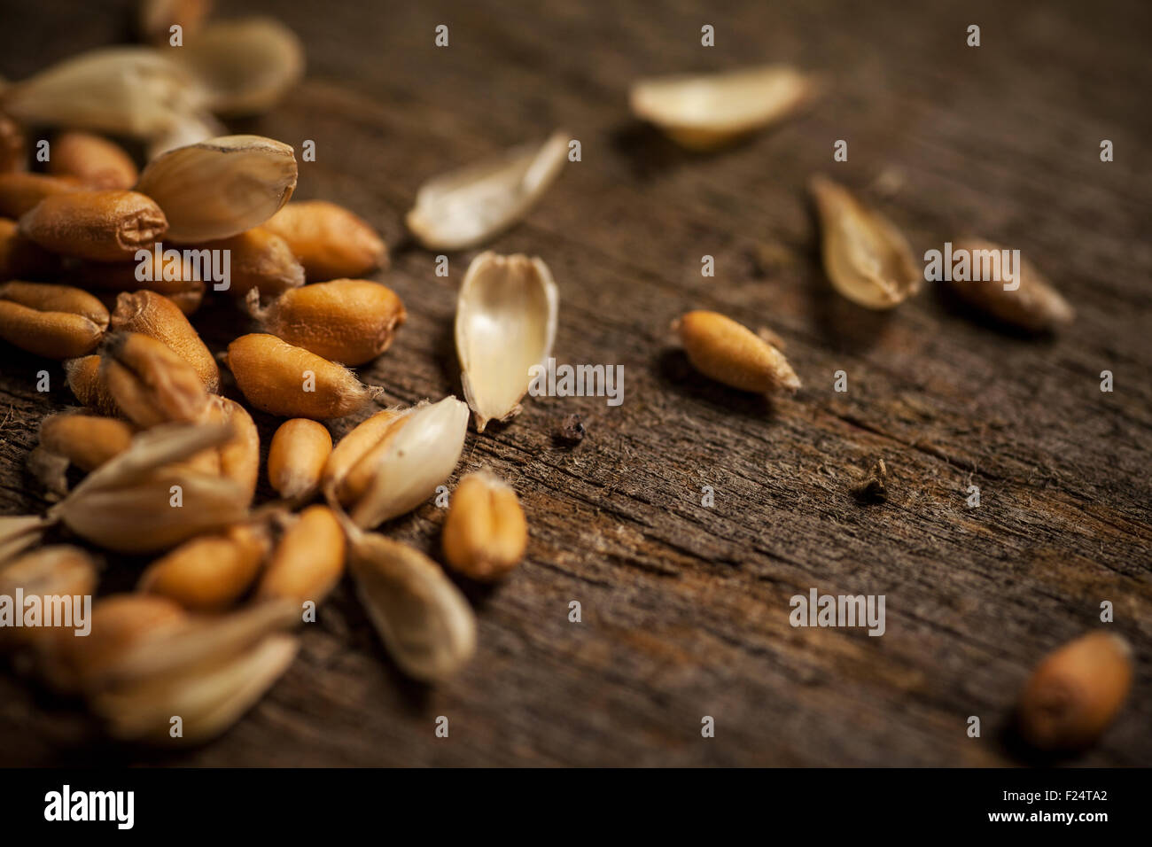 Close up of wheat seeds on a rustic wooded surface Stock Photo - Alamy