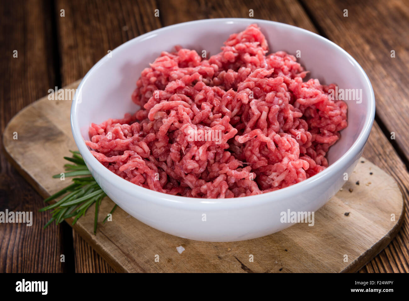 Minced Meat (Beef) as detailed close-up shot on dark wooden background ...