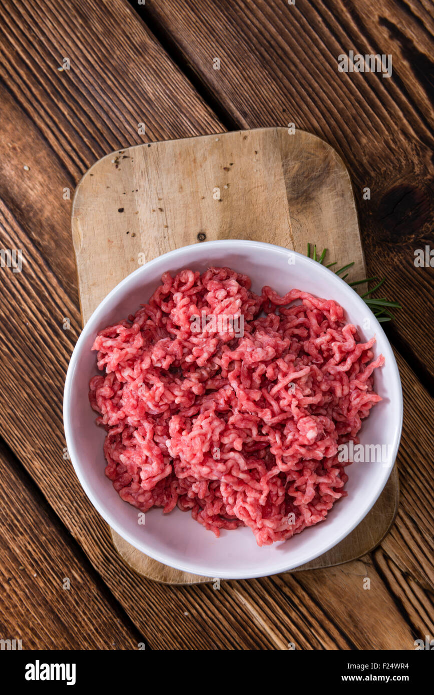 Minced Meat (Beef) as detailed close-up shot on dark wooden background ...