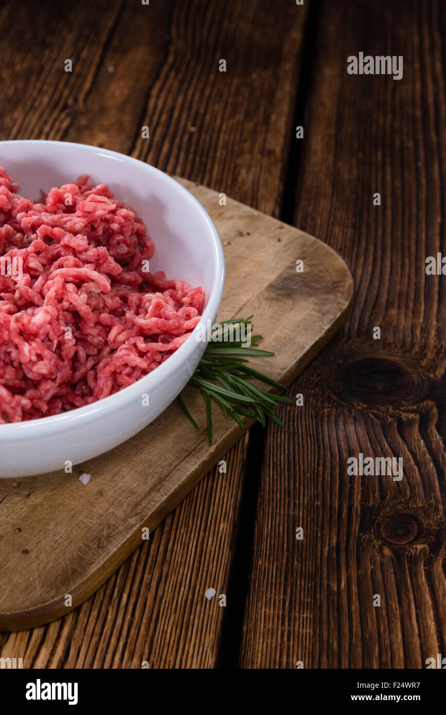 Minced Meat (close-up shot) on vintage wooden background Stock Photo ...