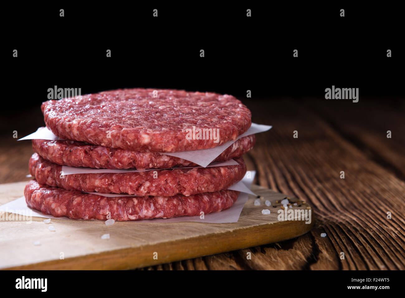 A raw Burger (minced Beef) on dark wooden background Stock Photo - Alamy