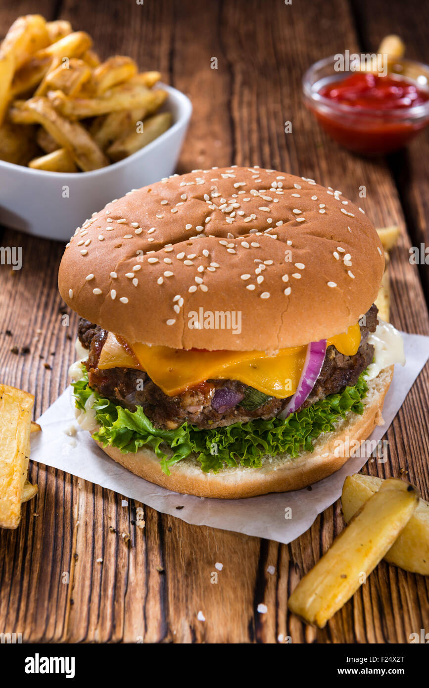 Homemade Beef Burger with Cheese and Chips on wooden background Stock ...