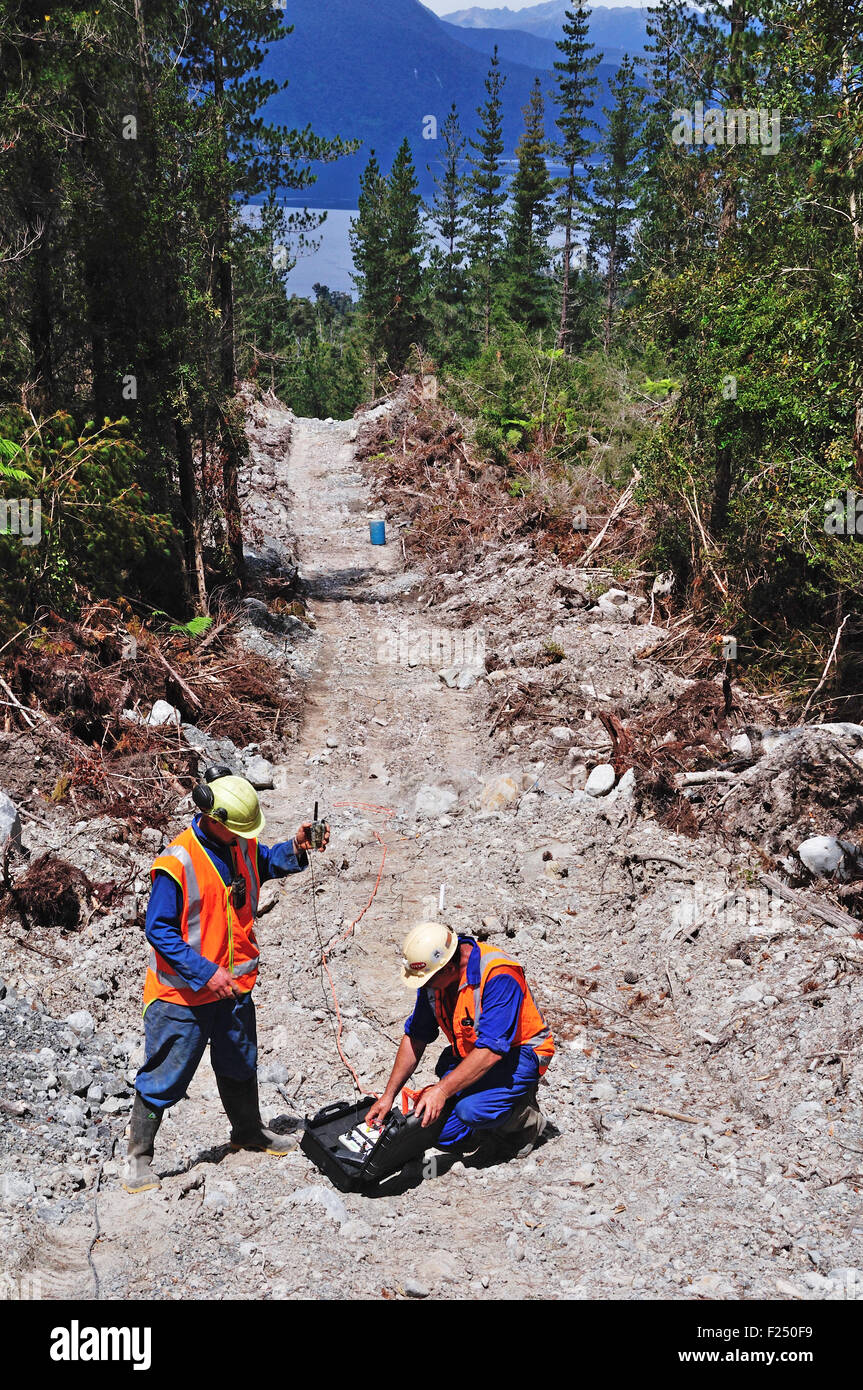 Men set off explosive charges in a seismic reflective survey looking ...