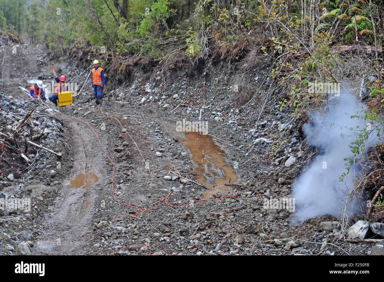 Men setting off explosive charges in a seismic reflective survey ...