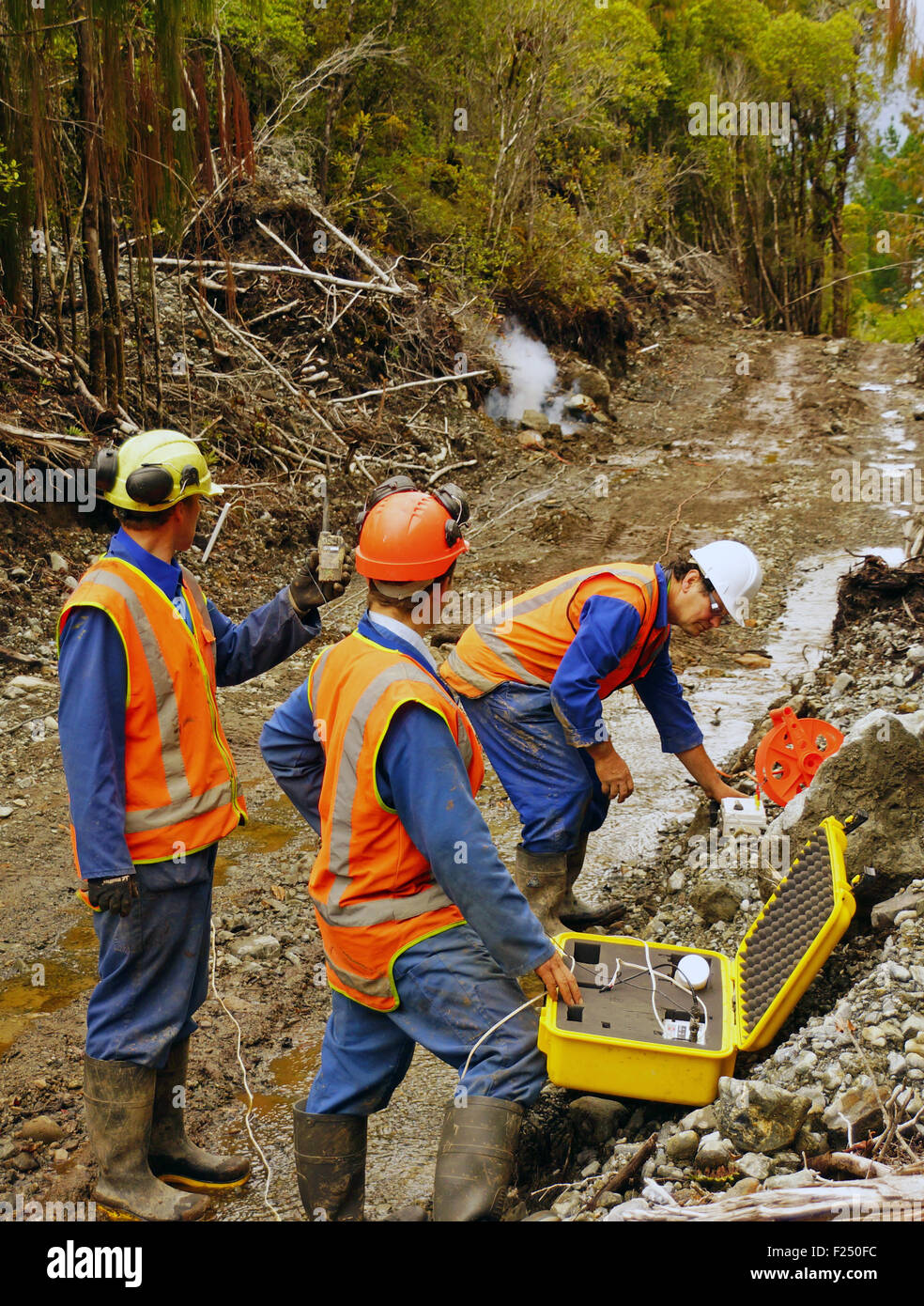 Men setting off explosive charges in a seismic reflective survey ...