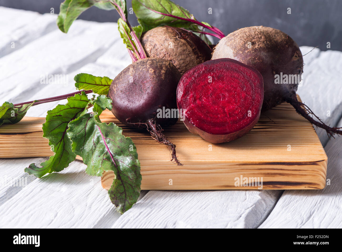Beetroots on white painted rustic wooden table with slate background ...