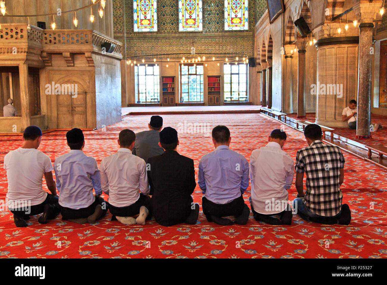 Young men praying in the Blue mosque, Istanbul Stock Photo - Alamy
