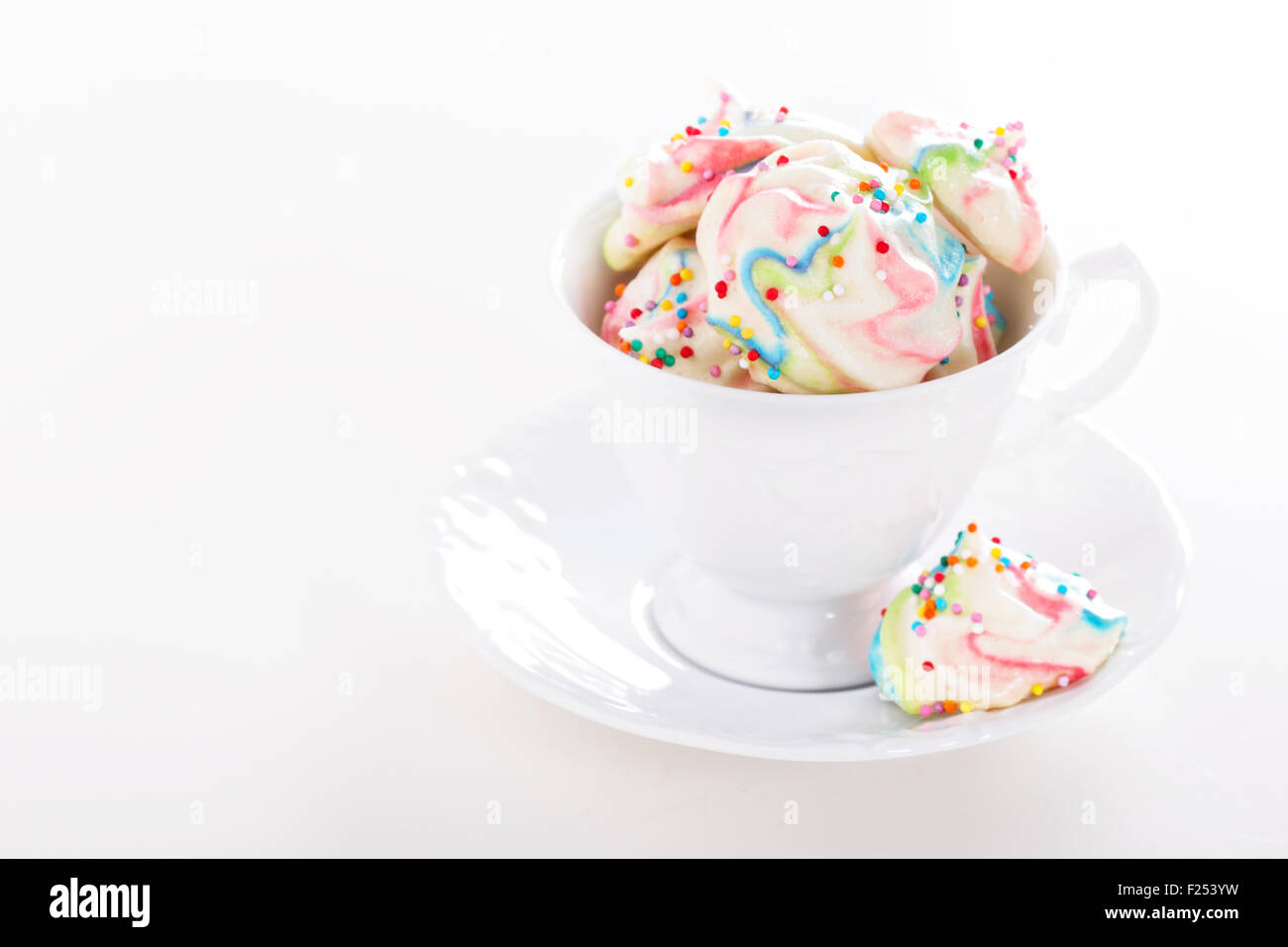 Colorful meringues painted rainbow colors with sprinkles Stock Photo ...